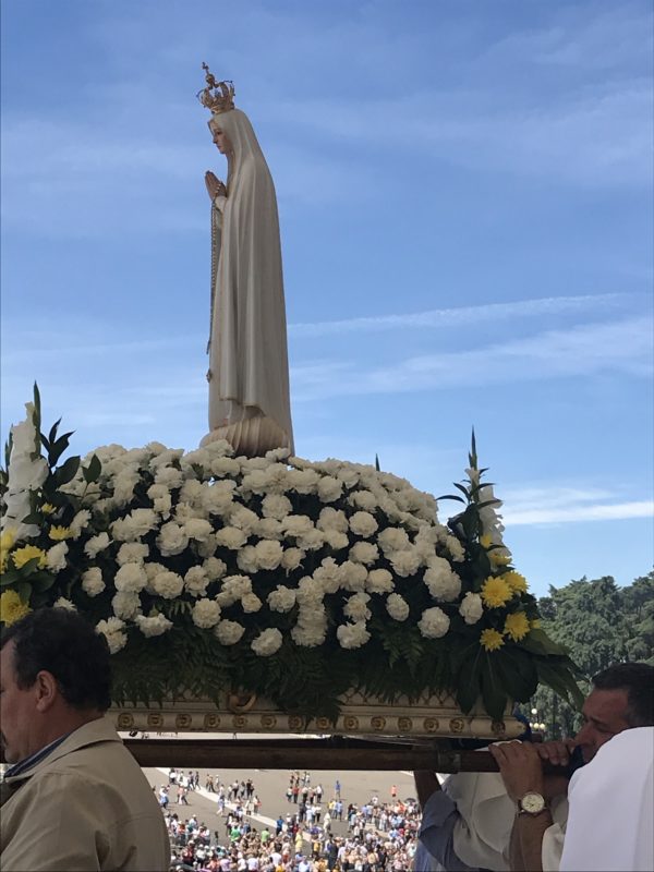 Our Lady of Fatima is carried to the altar for Sunday Mass at the open ...